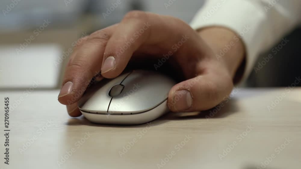 Close-up of a man hand uses white wireless mouse. Closeup male hand ...