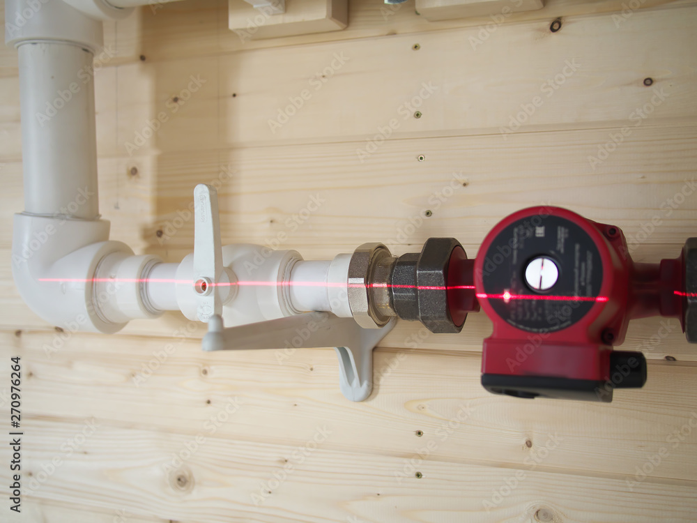 Foto Stock mounting of gravity heating system equipment with laser ...