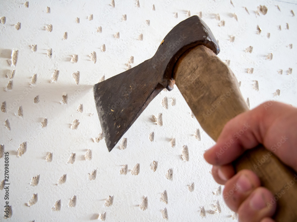 Preparation of the painted surface under the tile with an ax Stock ...