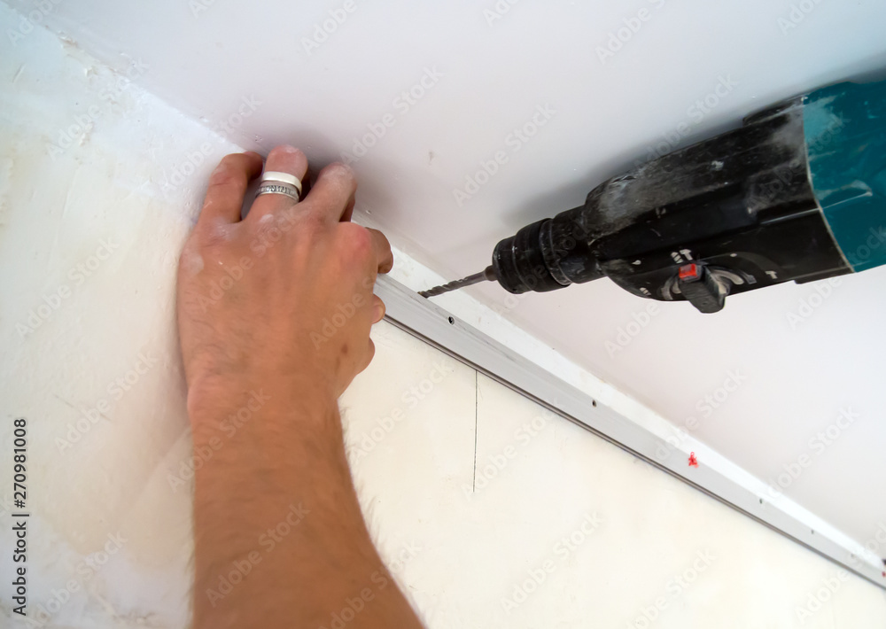 Fastening to the wall guide for stretch ceiling Stock Photo | Adobe Stock