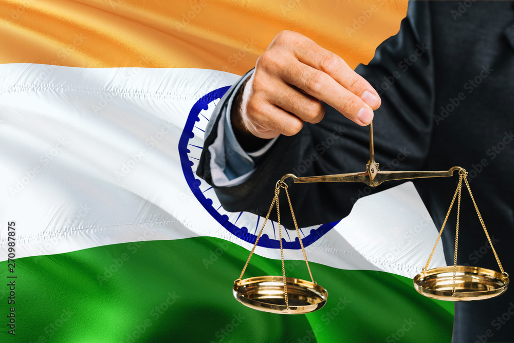 Indian Judge is holding golden scales of justice with India waving flag ...