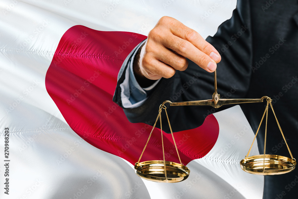 Japanese Judge is holding golden scales of justice with Japan waving ...