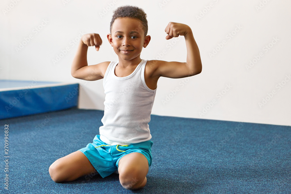 Portrait of happy cheerful dark skinned boy with short Afro hairstyle ...