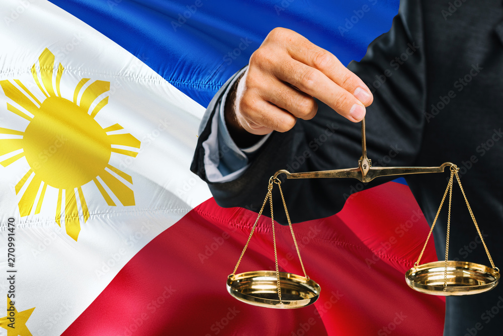 Filipino Judge is holding golden scales of justice with Philippines ...