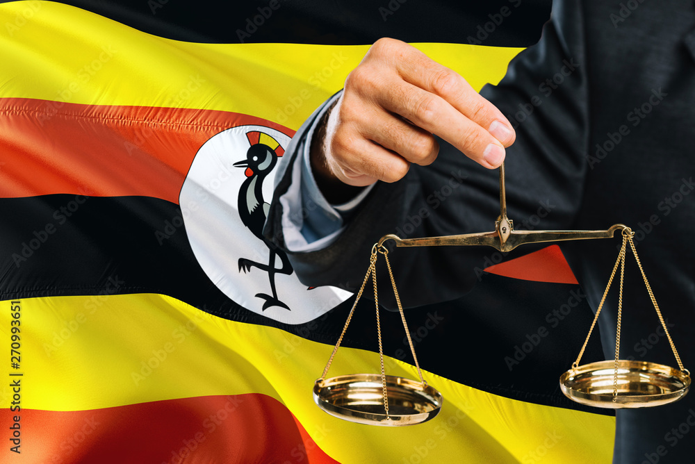 Ugandan Judge is holding golden scales of justice with Uganda waving ...