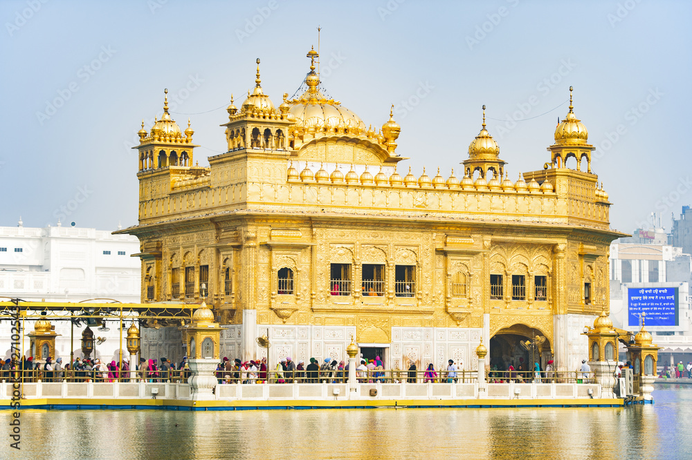 Tourists and pilgrims waiting in line at the entrance The Harmandir ...
