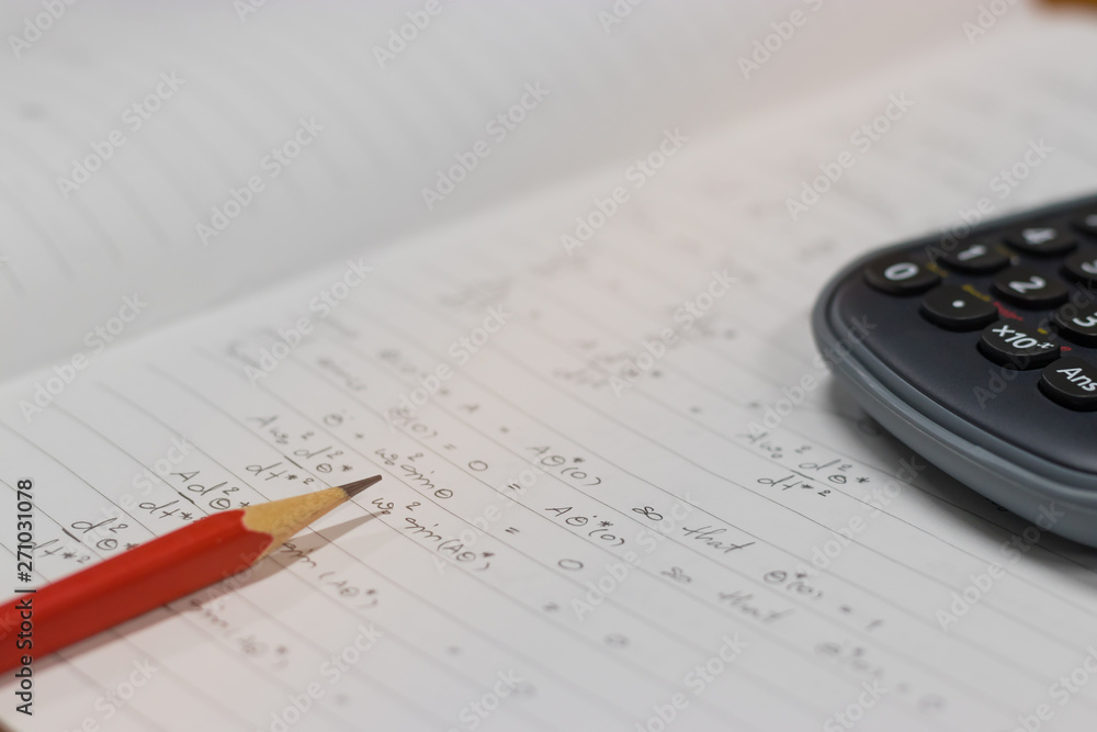 Close-up red pencil on paper use for compute the Physics problem using ...