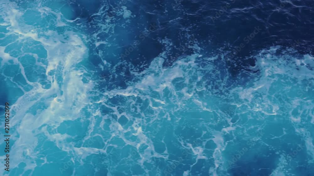 Waves with foam behind a boat. Patterns of waves in water. Water ...