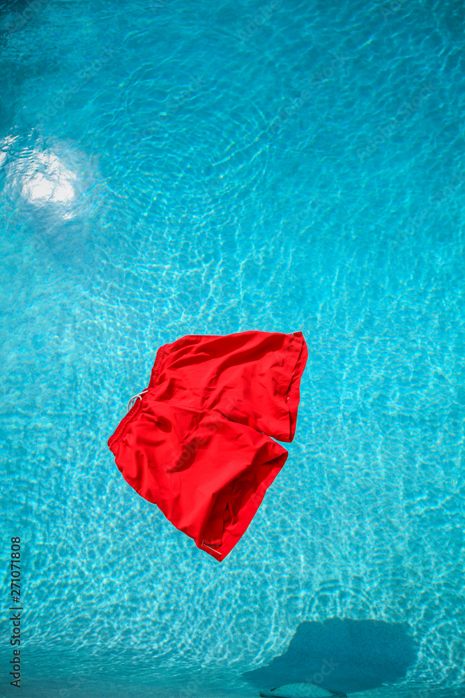 red swimming trunks floating in a swimming pool - Caught With Your ...