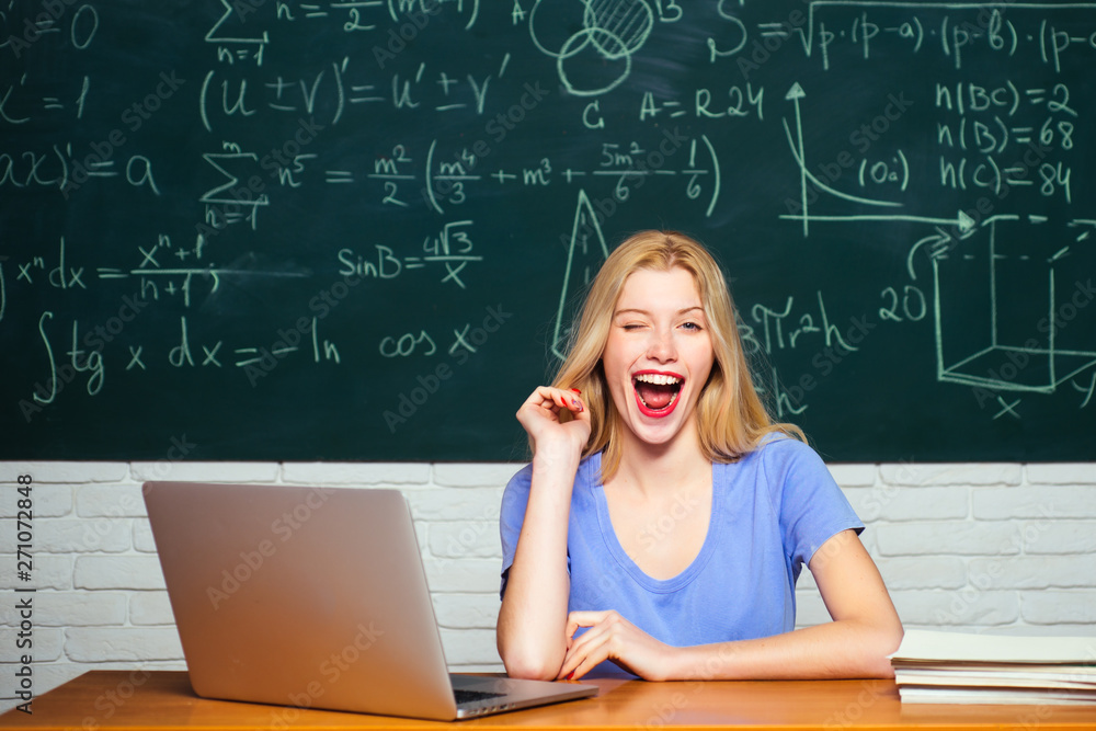 Student girl with happy face expression near desk with school supplies ...