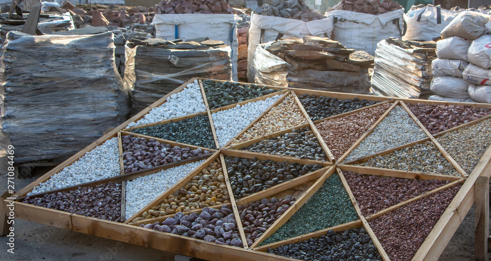 Multi-colored samples of marble, granite, and travertine chips and ...