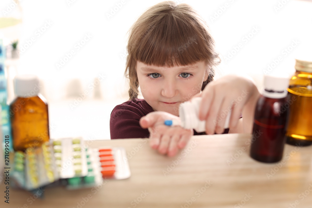 Little child taking pills from shelf at home. Danger of medicament ...