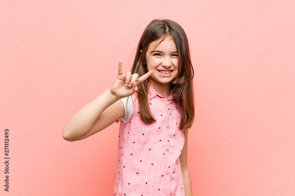 Cute little girl showing a horns gesture as a revolution concept. Stock ...