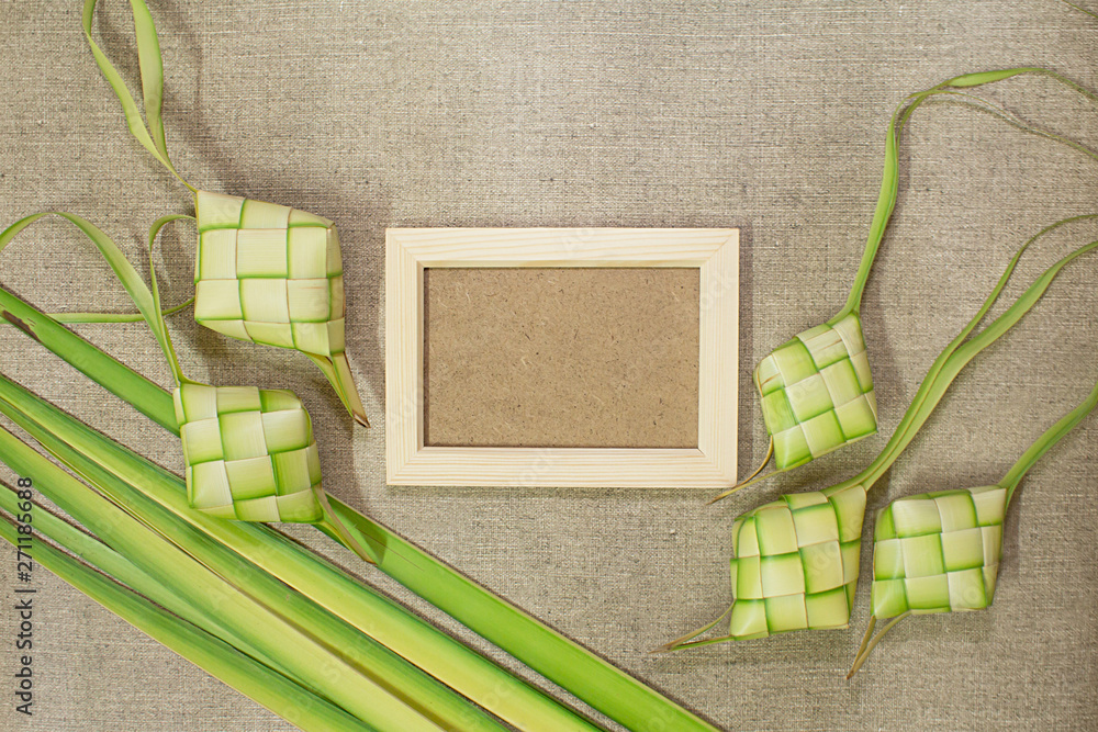 Ketupat (rice dumpling) with wooden frame on jute texture background ...