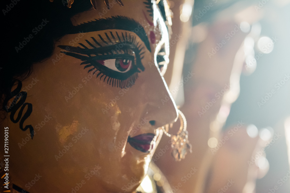 Close up side view face of Goddess Maa Durga Idol. A symbol of strength ...