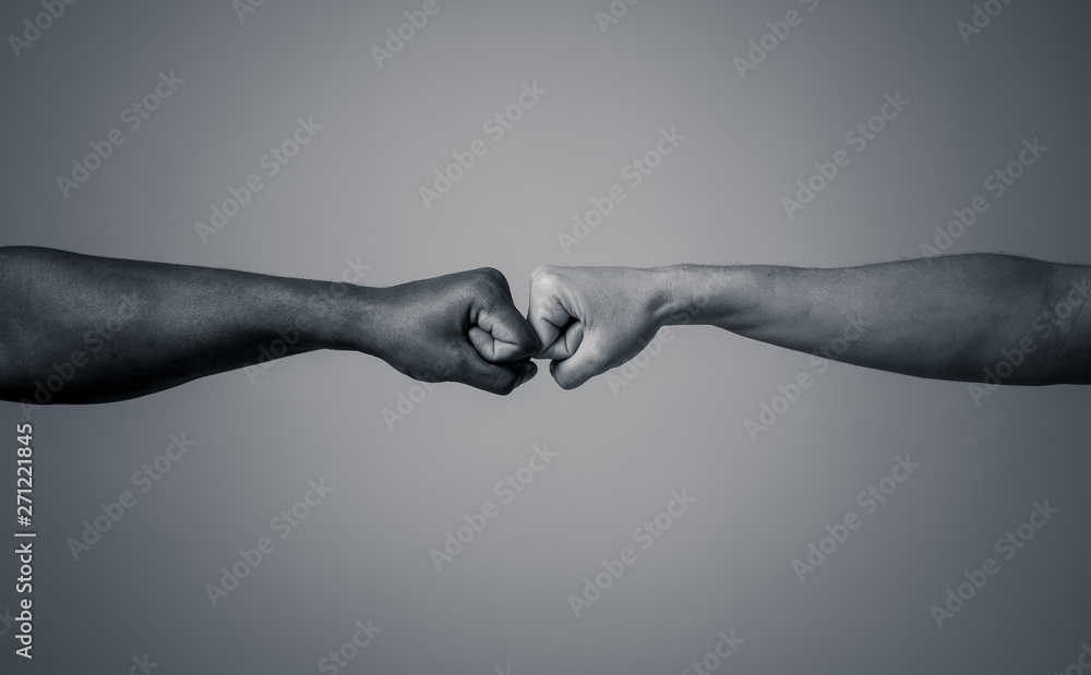 Fist of different skin colors giving fist bump. Conceptual image of ...