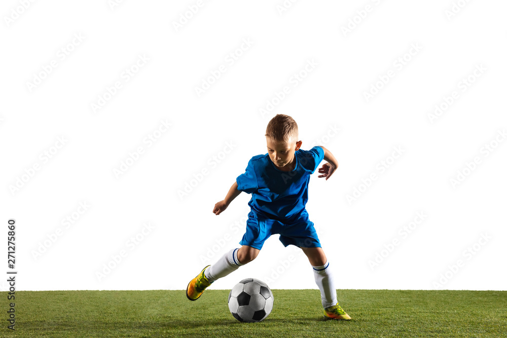 Young boy as a soccer or football player in sportwear making a feint or ...