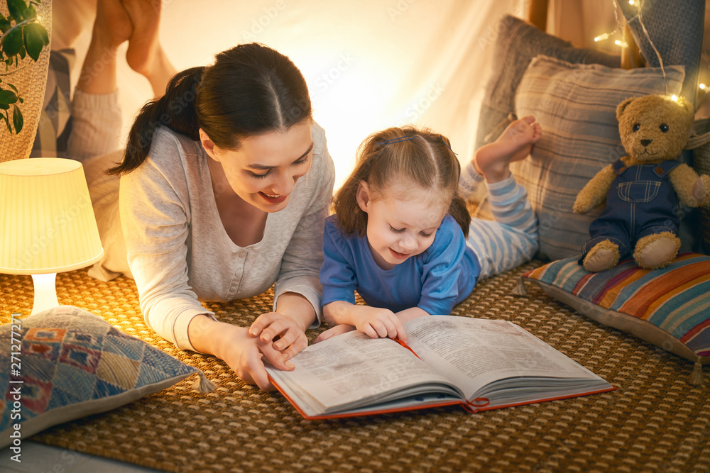 Mom and child reading a book Stock Photo | Adobe Stock