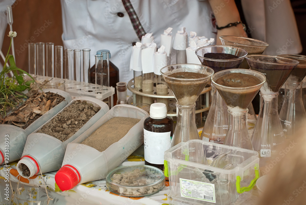 Soil experiments at the scientific fair. Test tubes with soil samples ...