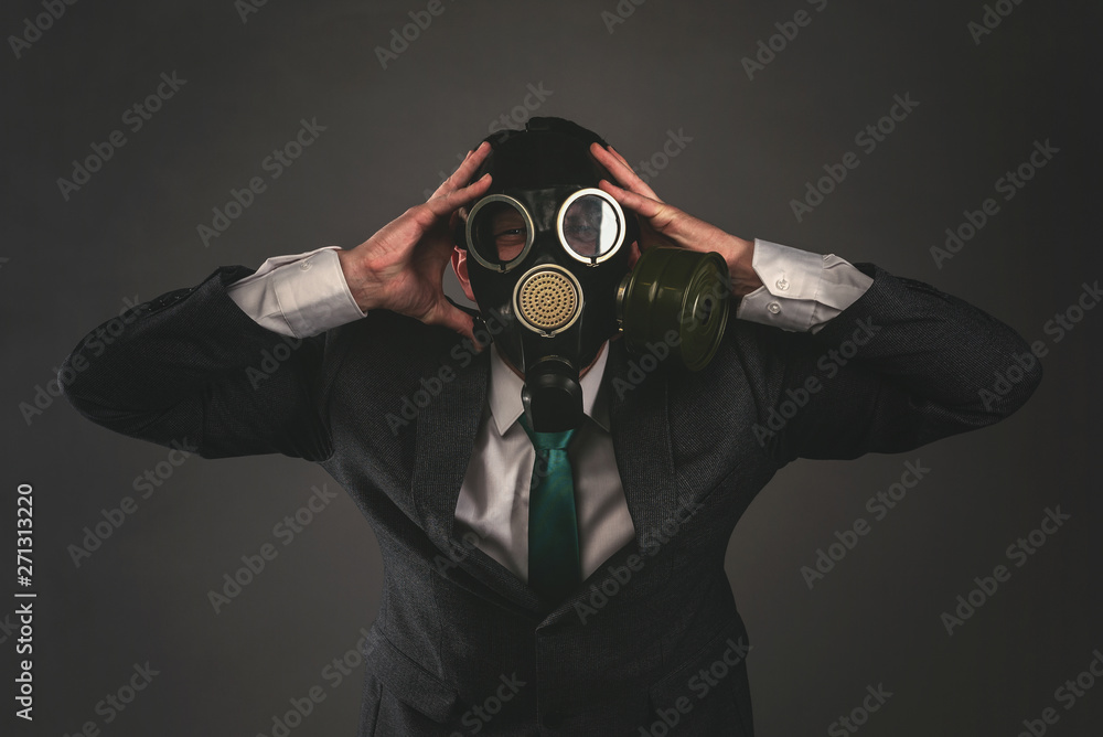 Shocked man in a gas mask is holding his hands on his head. Air ...
