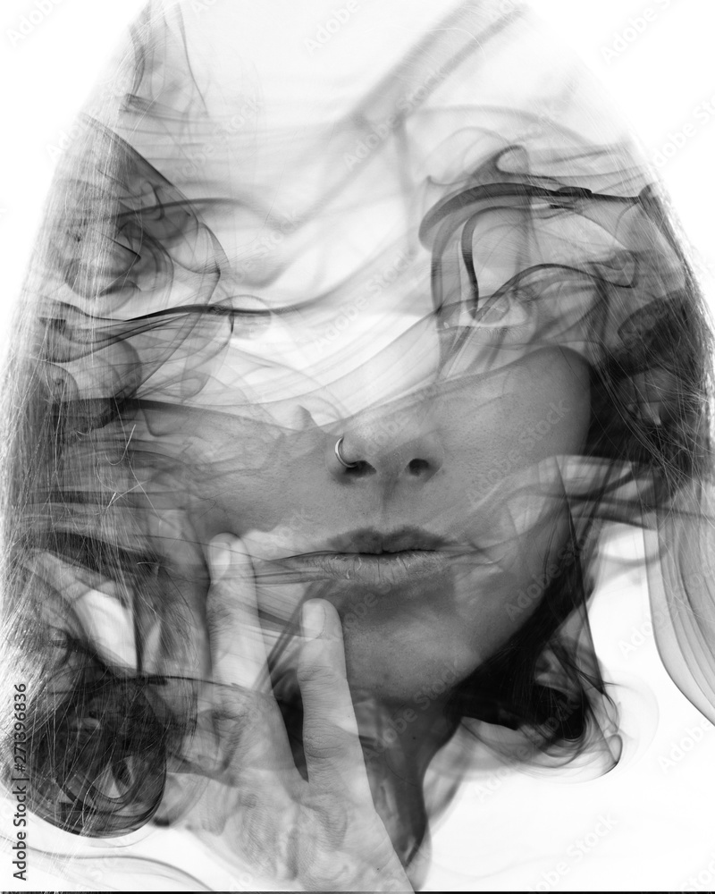 Double exposure portrait of a sensual model gently touching her face ...