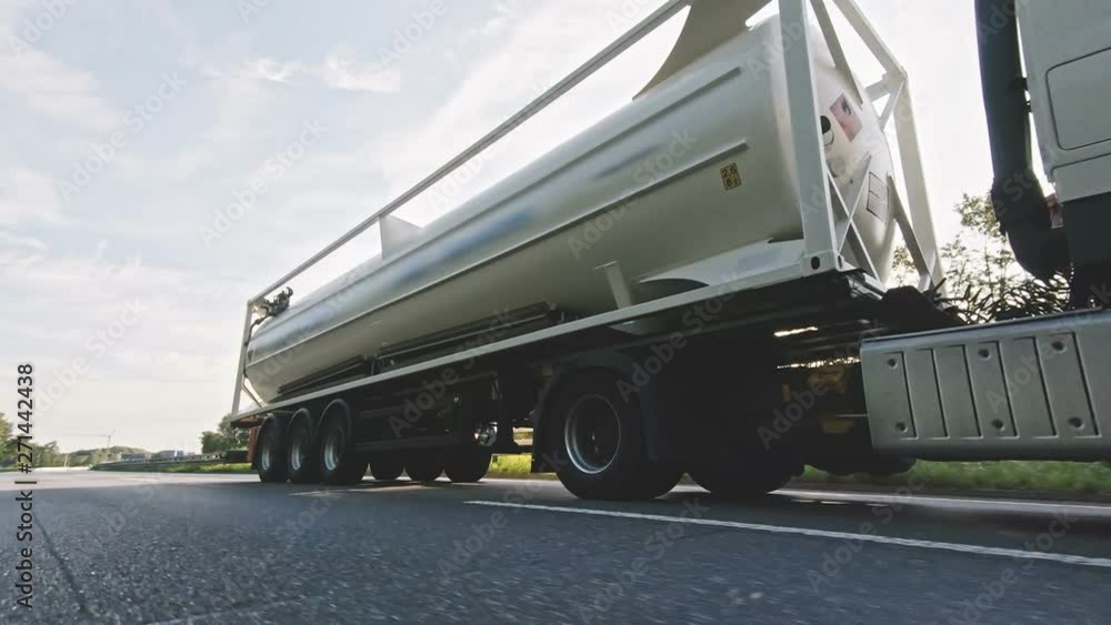 Cargo truck with fuel diesel cargo trailer driving on a highway. White ...
