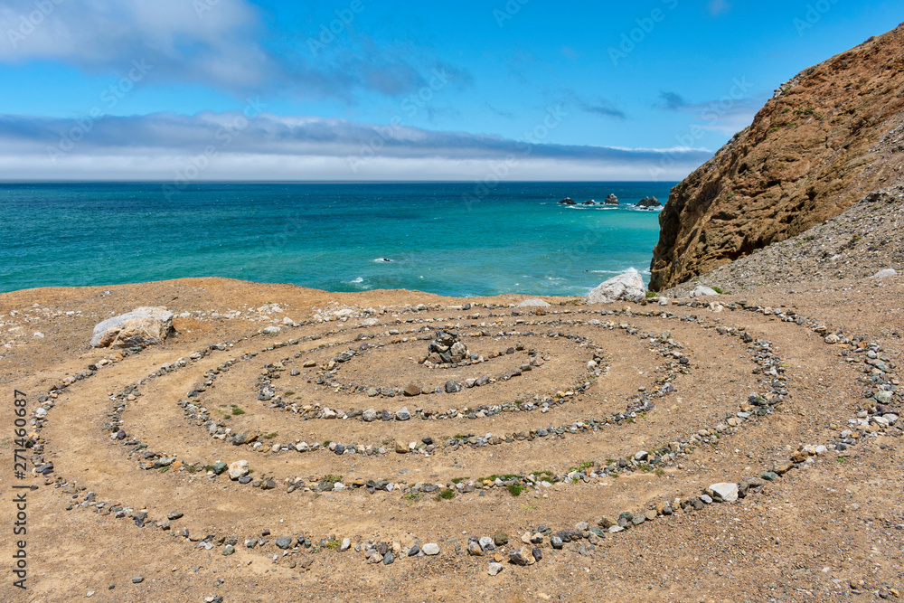 Stone labyrinth or maze on ocean cliff with scenic coast view in ...