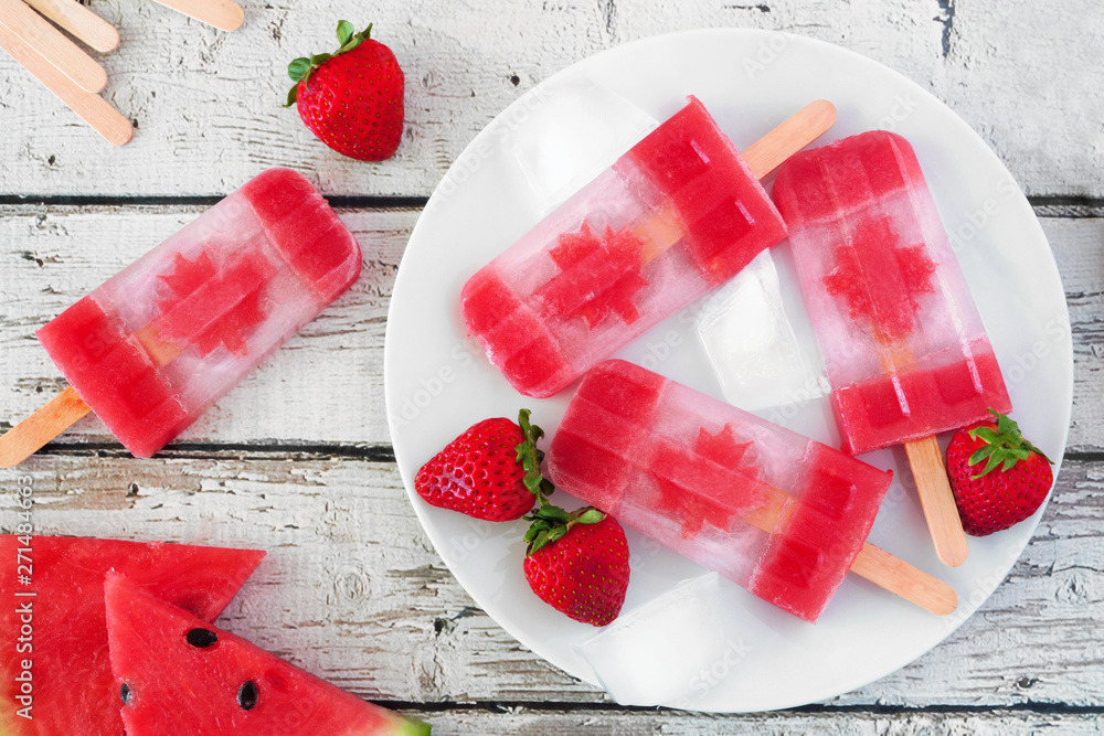 Canadian flag popsicles, above scene on a rustic white wood background ...