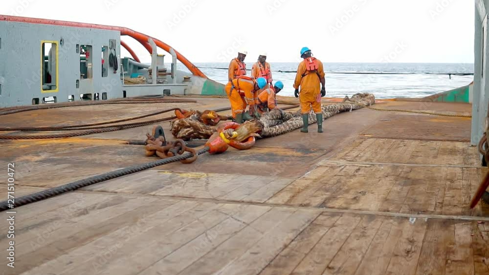 Anchor-handling Tug Supply AHTS vessel crew preparing vessel for static ...