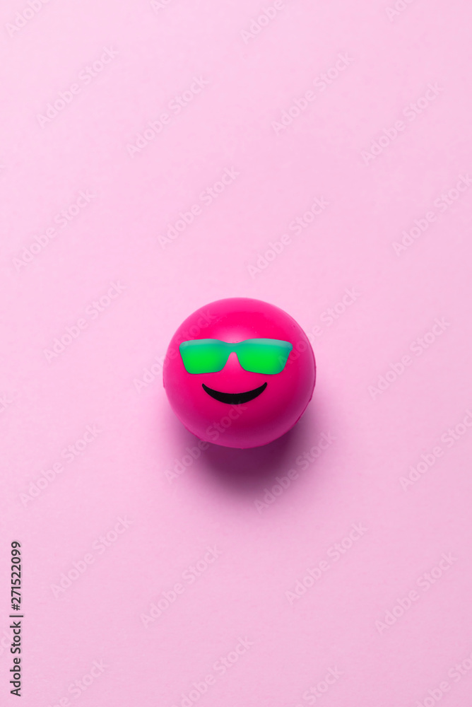 Smiling pink emoticon ball with sunglasses Stock Photo | Adobe Stock