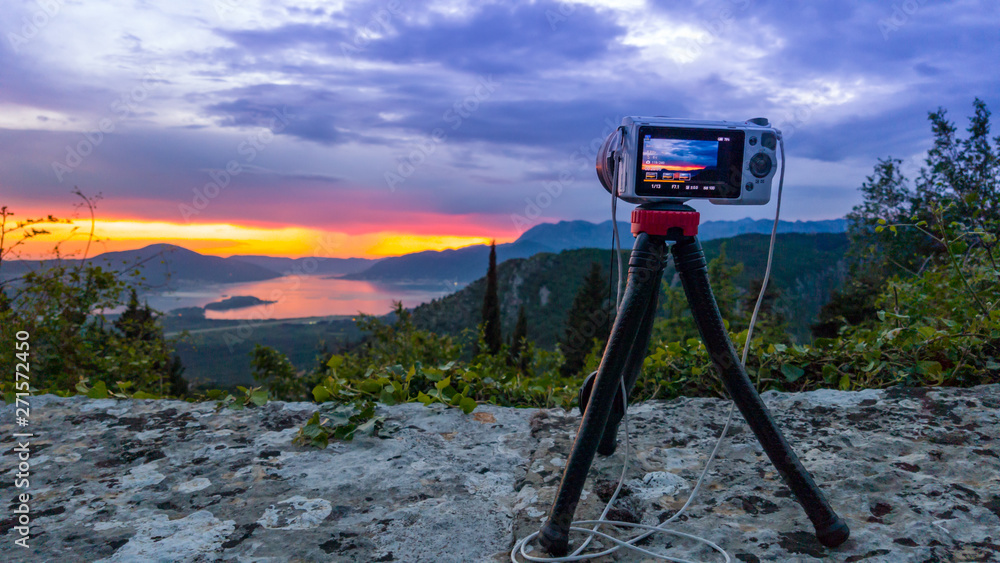 Camera capturing sunset shot. Photography using on tripod against sun ...