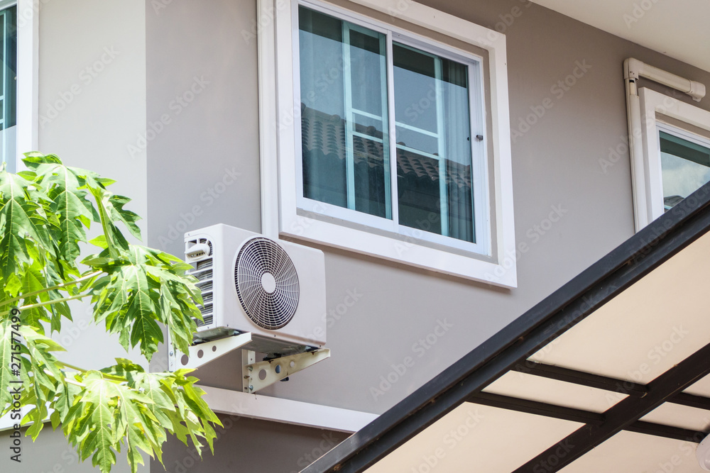 Air conditioner compressor outdoor unit installed outside the house ...