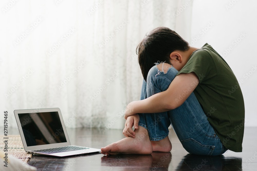 Cyberbullying and Depression. Asian teenage boy sitting alone and ...