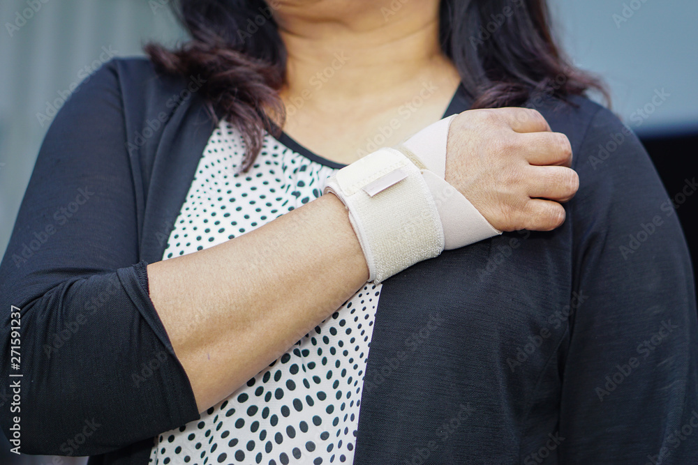 Asian middle-aged lady woman use elastic bandage to treating De ...