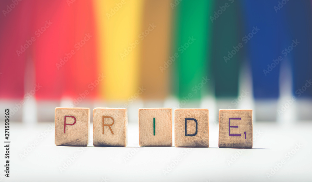 Pride sign made with colorful wooden alphabet letters on a pride LGBT ...