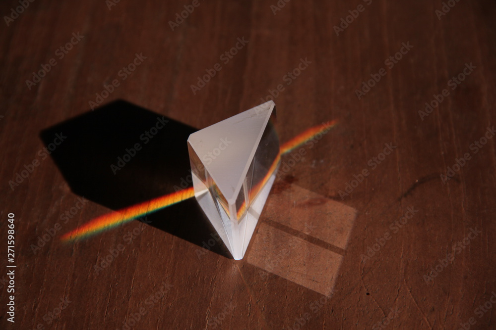 Natural light focuses on the optical prism, refracting a color spectrum ...