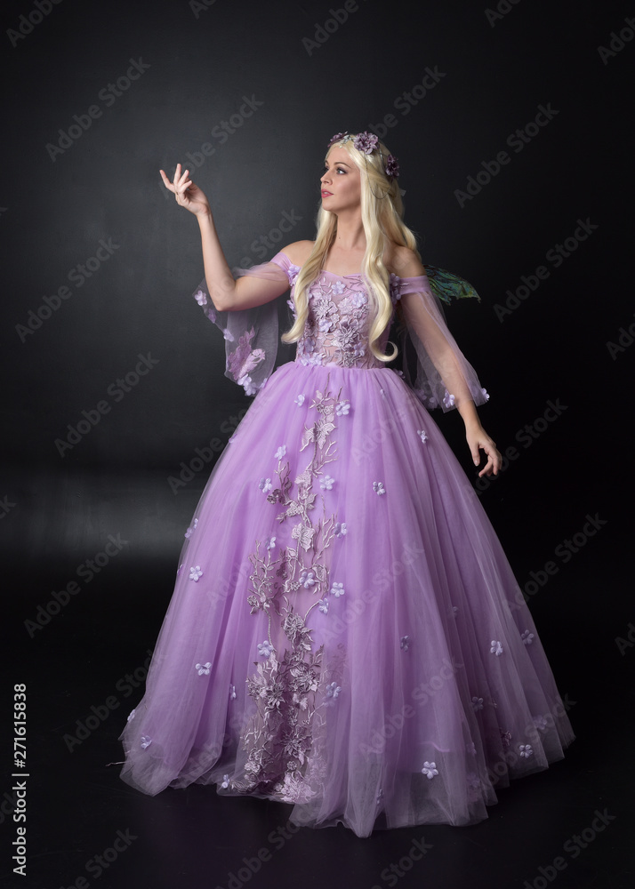 full length portrait of a blonde girl wearing a fantasy fairy inspired ...