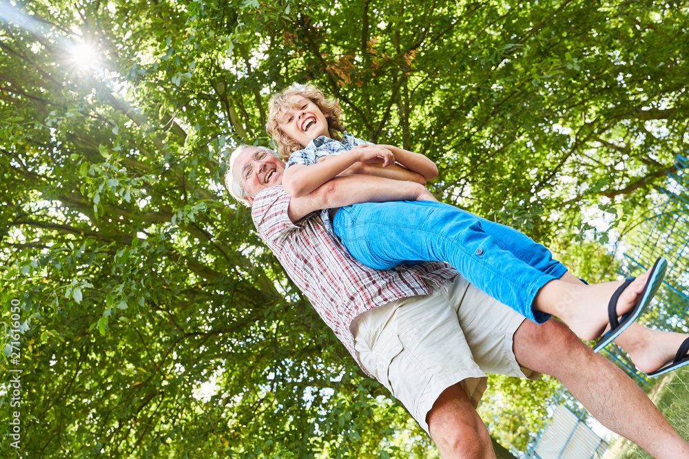 Grandfather and his grandson have fun in the park Stock Photo | Adobe Stock