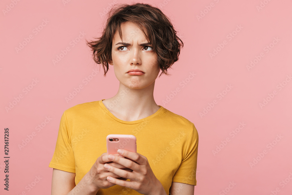 Confused young beautiful woman posing isolated over pink wall ...