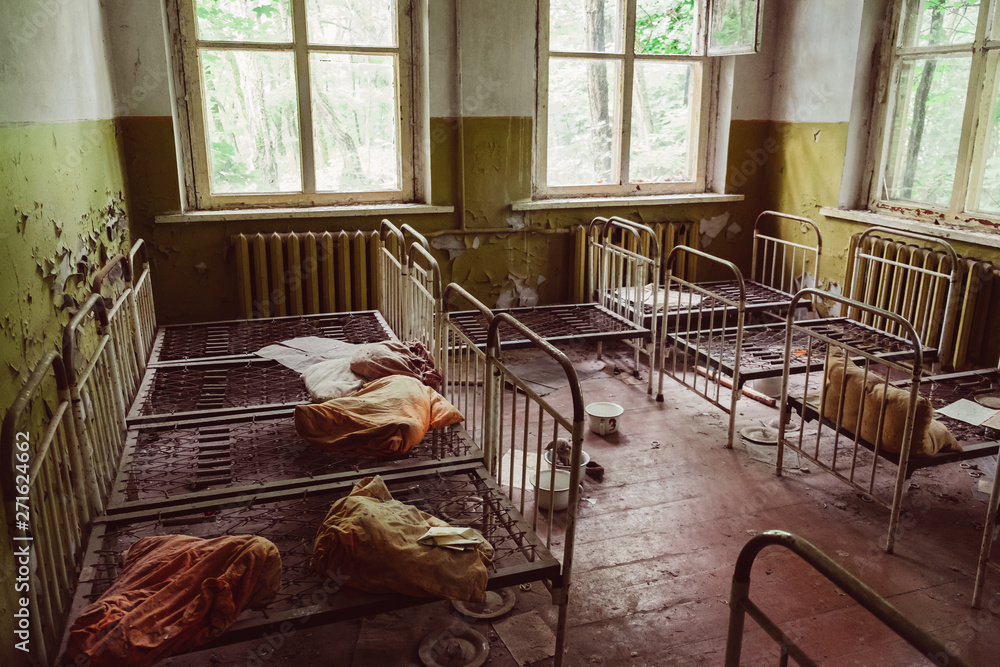 Old broken children beds in kindergarten, nursery school. Destroyed ...