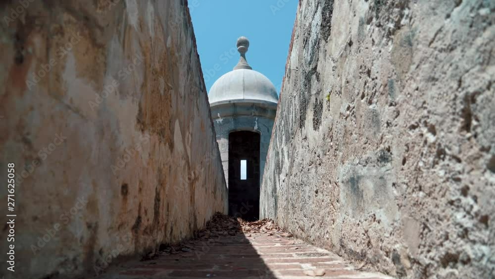 A slider low angle shot of one of El Morro's towers, the camera moves ...