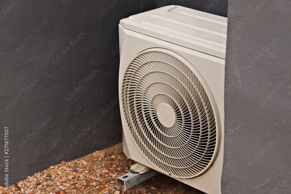 An air conditioner on the outside of a building. Heat wave concept ...