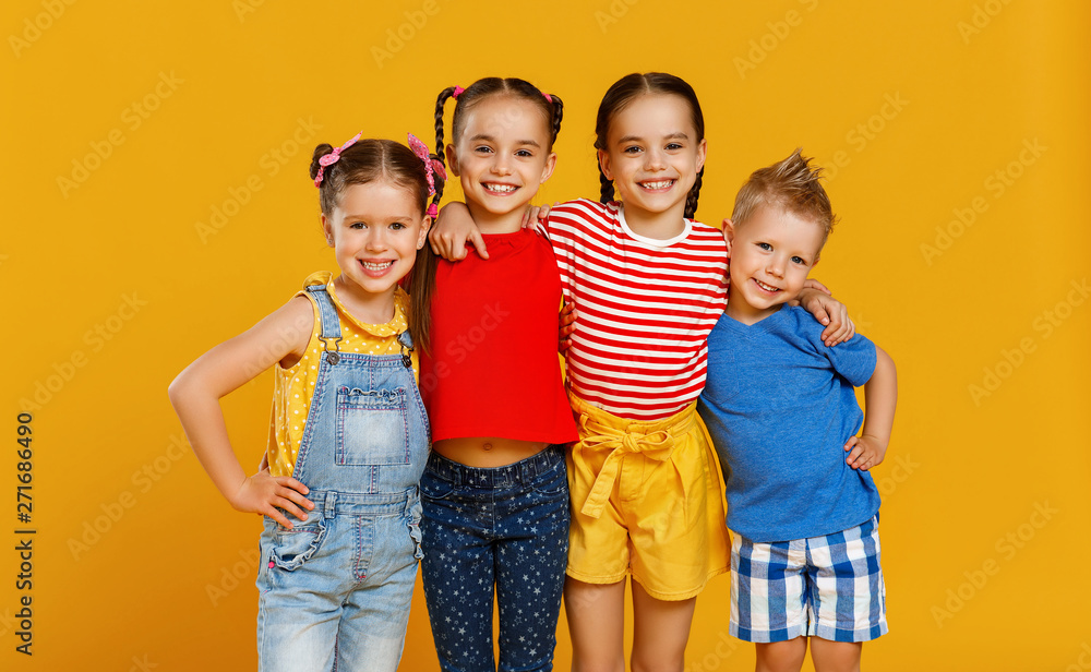 group of cheerful happy children on colored yellow background. Stock ...