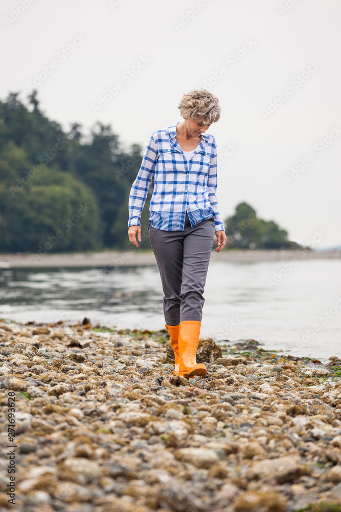 Beautiful, active, healthy middle aged mature woman enjoying exploring ...