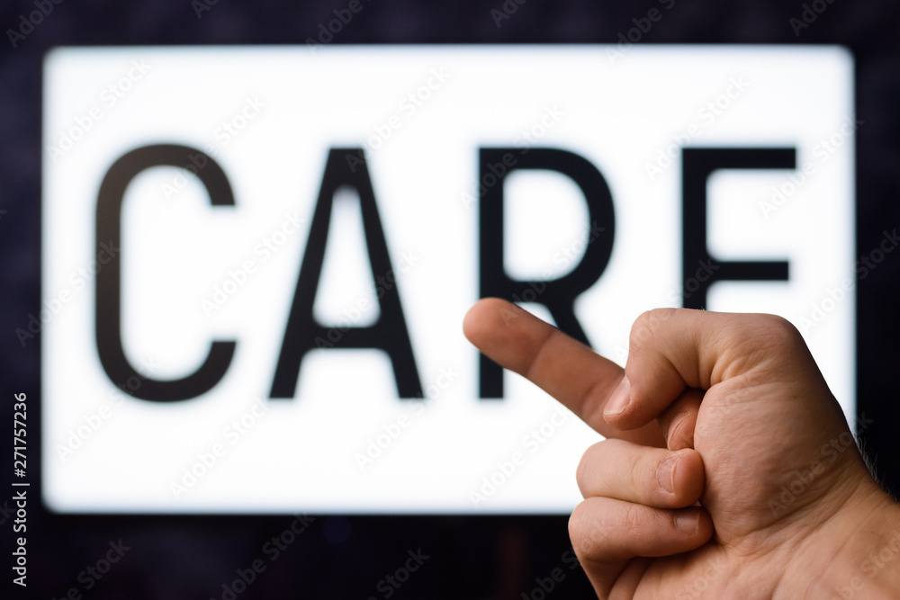 Male showing middle finger to the screen with inscription CARE. Symbol ...