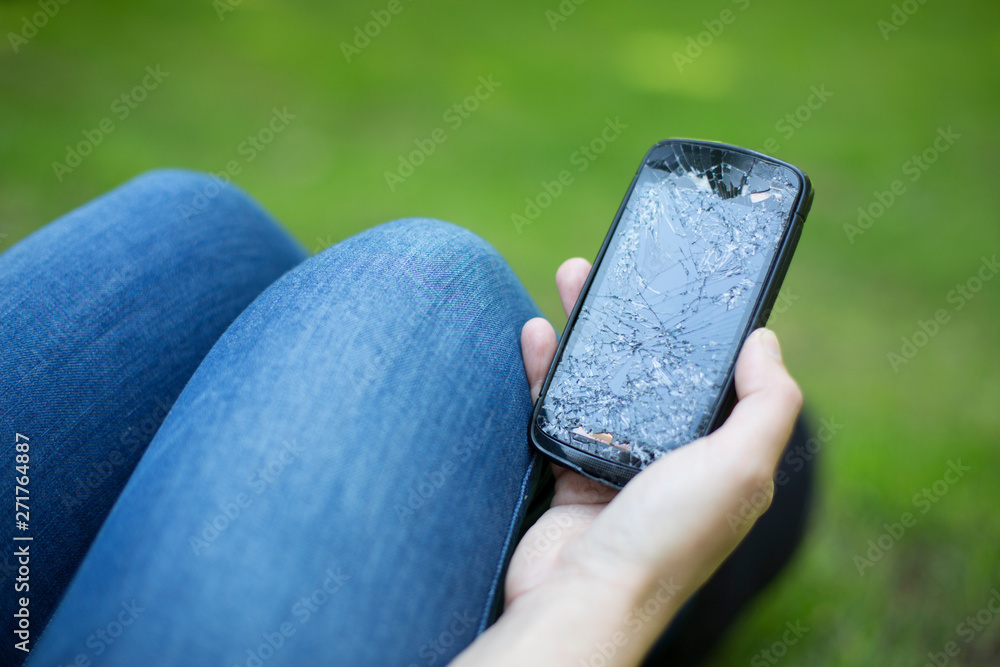 Broken glass screen smartphone in hand.Hand holding mobile phone with ...