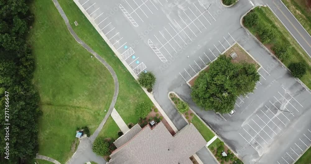 An aerial view of a suburban section prominently featuring a parking ...