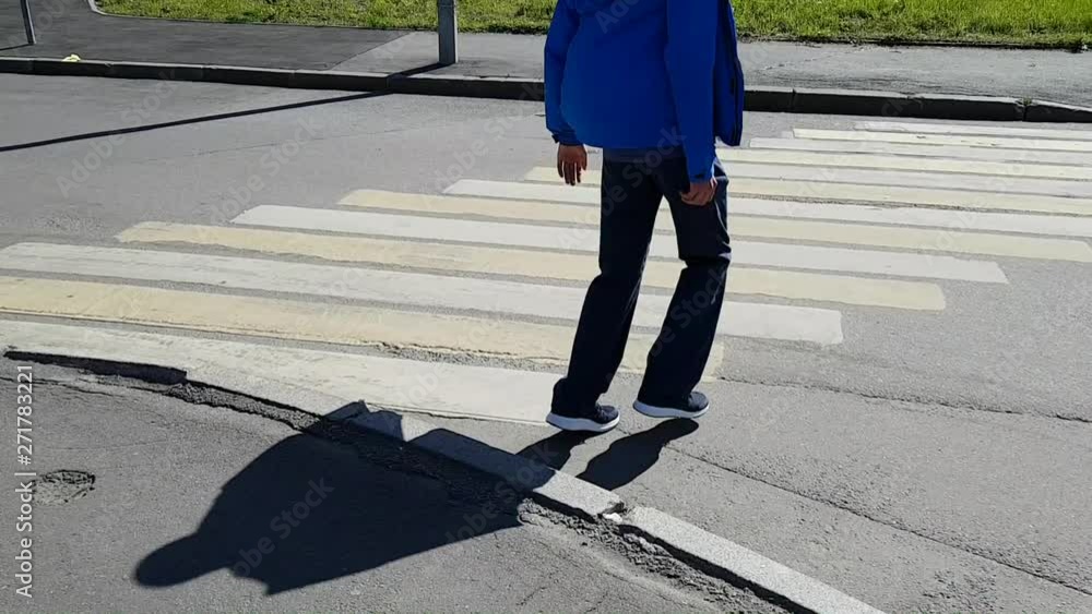 Limping a grown man enters the crosswalk. Puts his feet on tiptoe ...