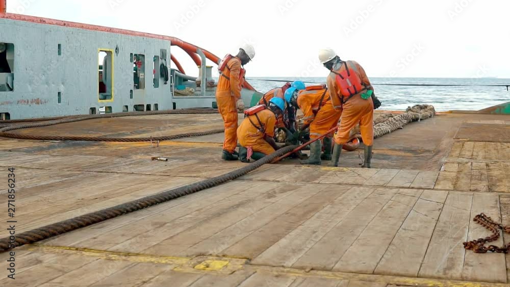 Anchor-handling Tug Supply AHTS vessel crew preparing vessel for static ...