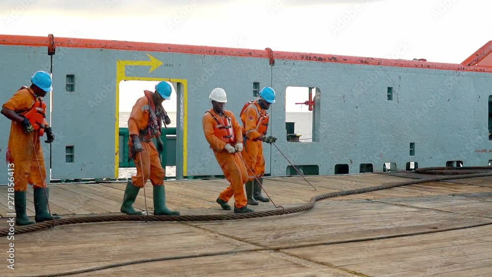 Anchor-handling Tug Supply AHTS vessel crew preparing vessel for static ...